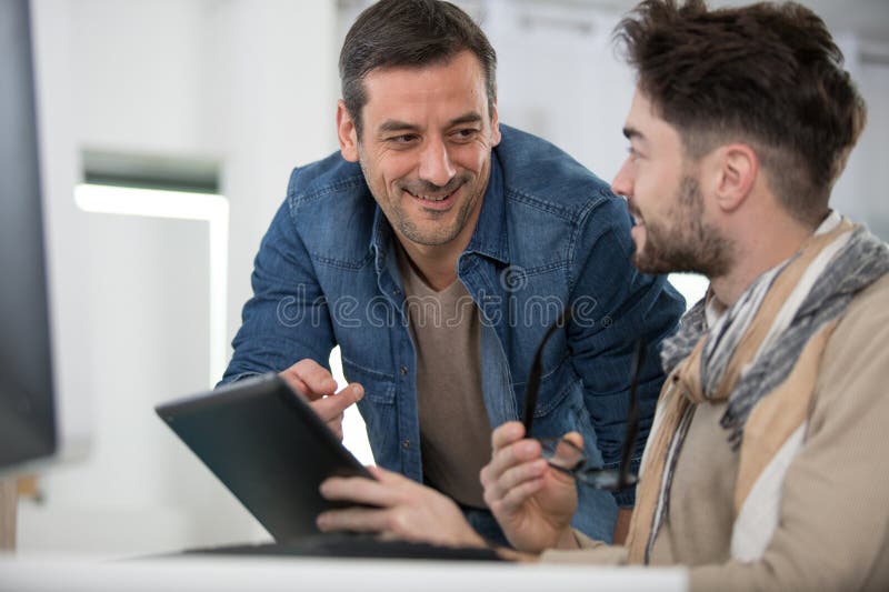 Male Teacher and Student Discussing Tablet Display Stock Photo - Image ...