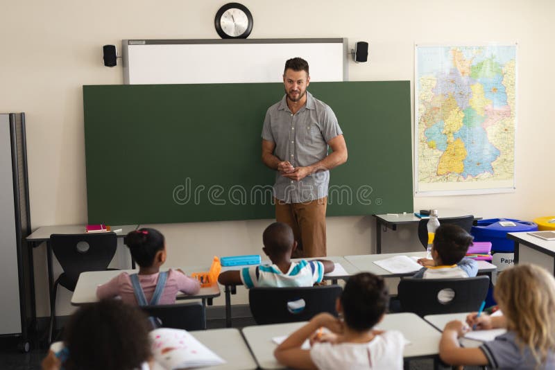 Male Teacher Teaching in Classroom of Elementary School Stock Image ...