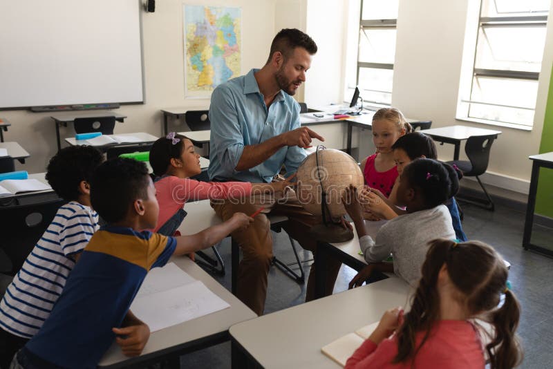 Male Teacher Teaching His Kids about Geography by Using Globe in ...