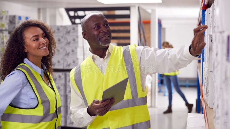 Male Team Leader with Digital Tablet in Warehouse Training Intern ...