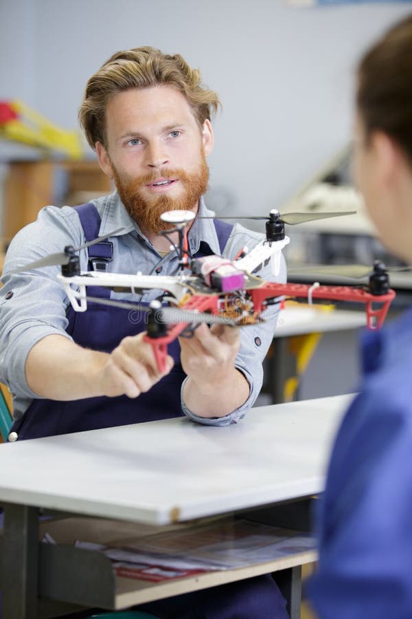 Male Technical Engineer Talking To Colleague while Repairing Drone ...