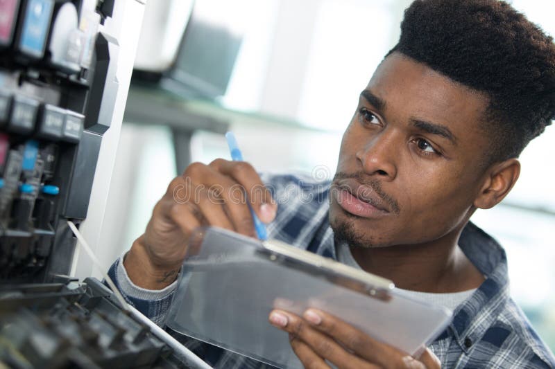 Male Technician Assessing Photocopier Stock Photo - Image of serious ...