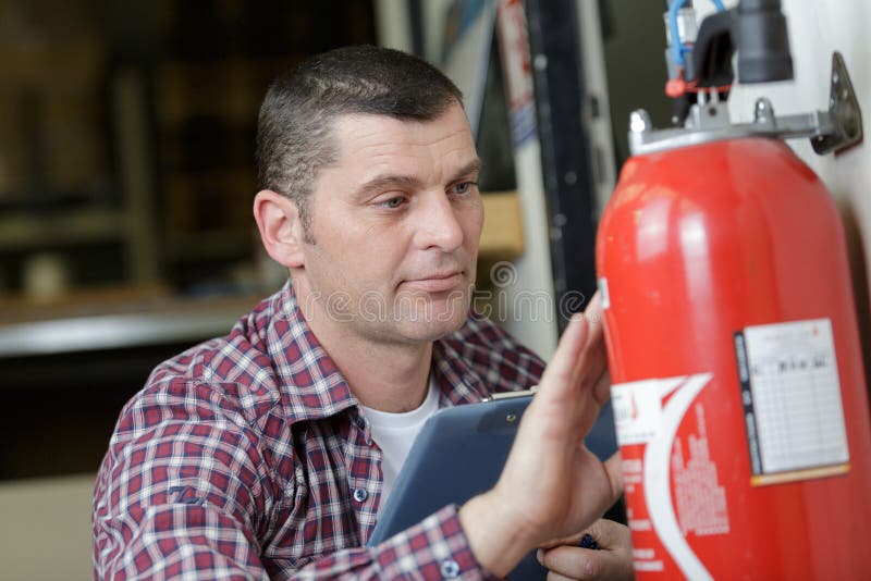 Man Checking Fire Extinguisher Writing Document Stock Photos - Free ...