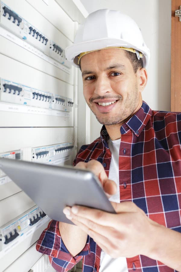 Male Technician Examining Fusebox with Tablet Pc Stock Image - Image of ...