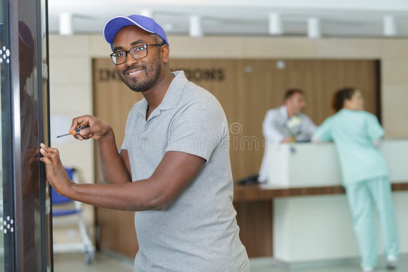Male Technician Fixing Fridge in Hospital Stock Image - Image of ...