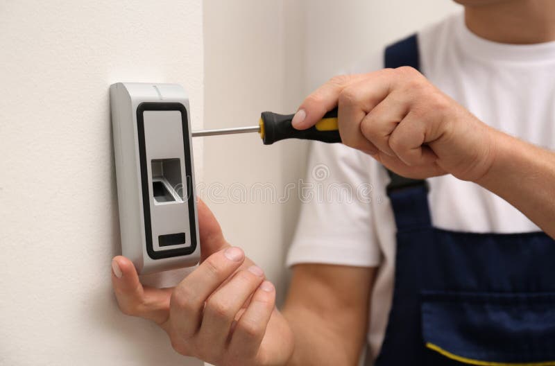 Male Technician Installing Fingerprint Security Alarm System Indoors ... Male Technician Installing Fingerprint Security Alarm System Indoors ...