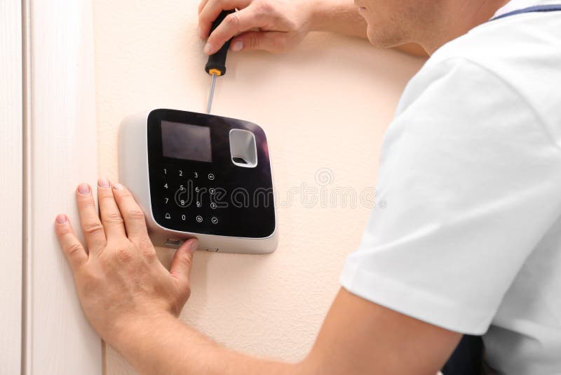 Male Technician Installing Security Alarm System Indoors Stock Photo ... Male Technician Installing Security Alarm System Indoors Stock Photo ...