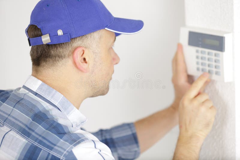 Male Technician Programming Electronic Keypad Stock Image - Image of ...