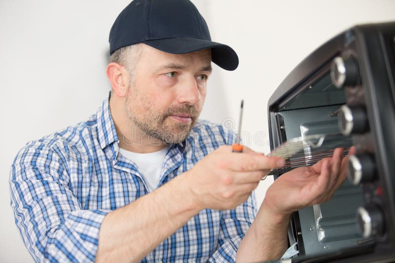 Male Technician Repairing Microwave Oven Stock Image - Image of adult ...