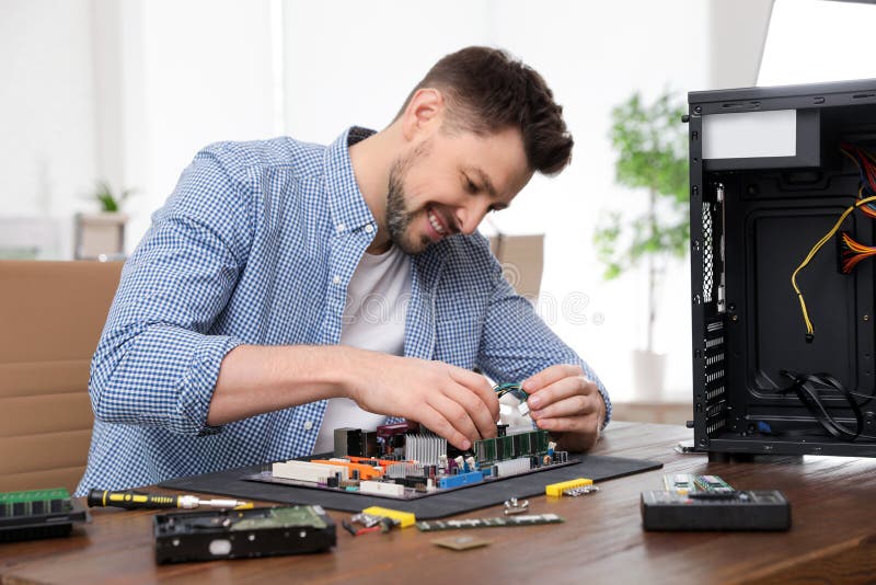 Male Technician Repairing Motherboard at Table Stock Photo - Image of ...