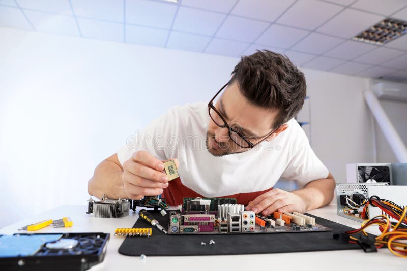 Male Technician Repairing Motherboard at Table Stock Photo - Image of ...
