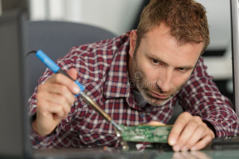 Male Technician Soldering Computer Component Stock Photo - Image of ...