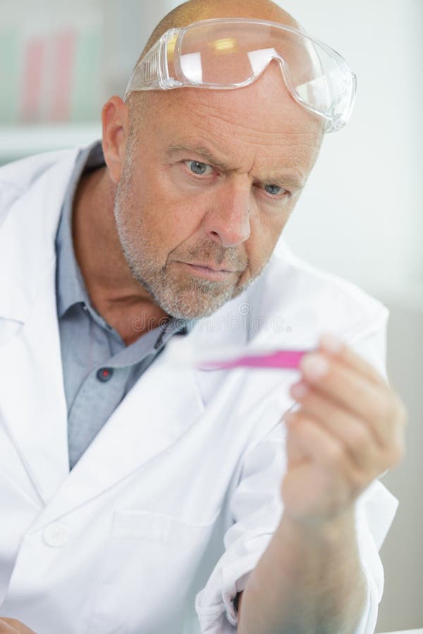 Technician Standing at Solar Station with Laptop in Hands and Showing ...