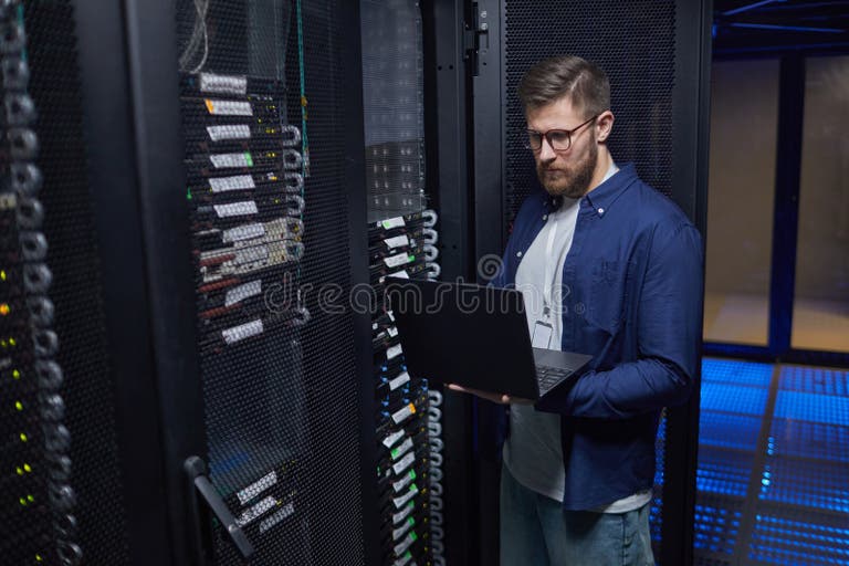 Technician Working in Server Room with Laptop Stock Image - Image of ...