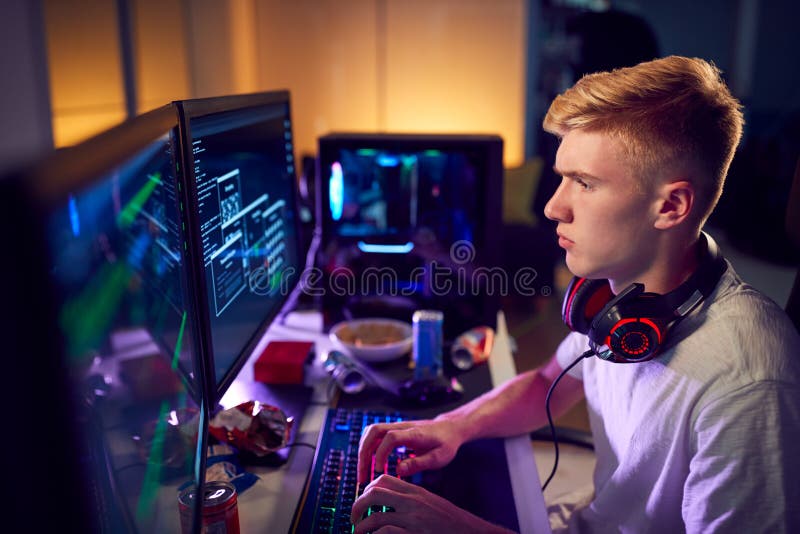 Male Teenage Hacker Sitting in Front of Computer Screens Bypassing ...