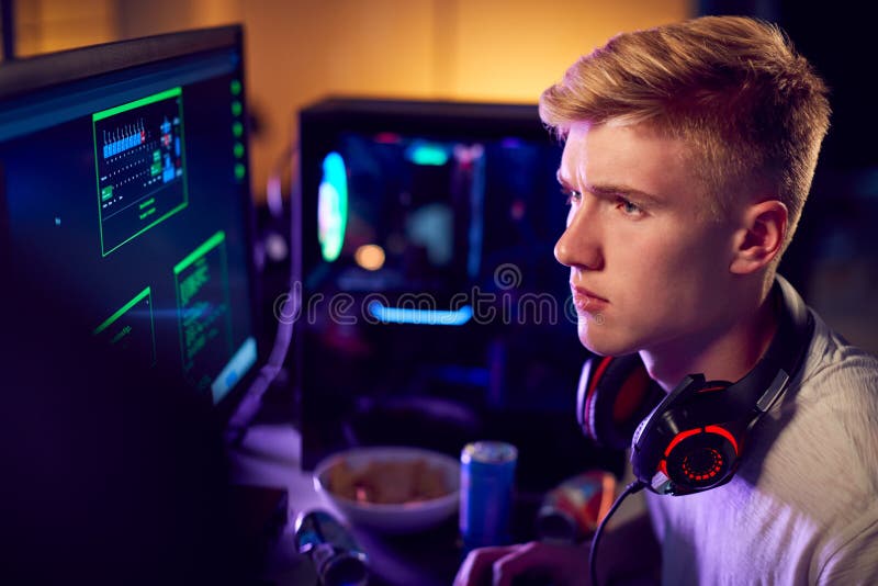 Male Teenage Hacker Sitting in Front of Computer Screens Bypassing ...