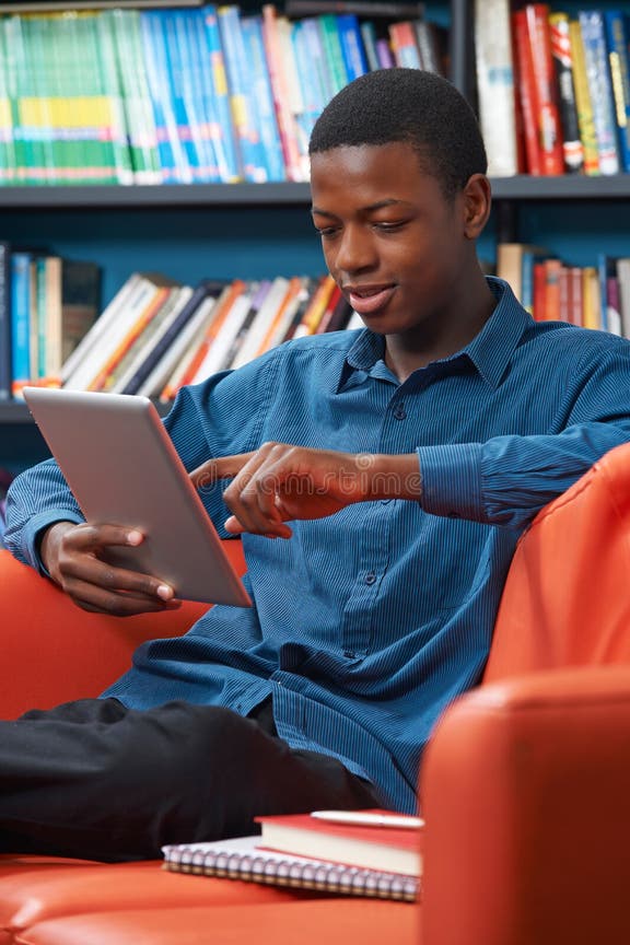 Male Teenage Student Using Digital Tablet in Library Stock Image ...