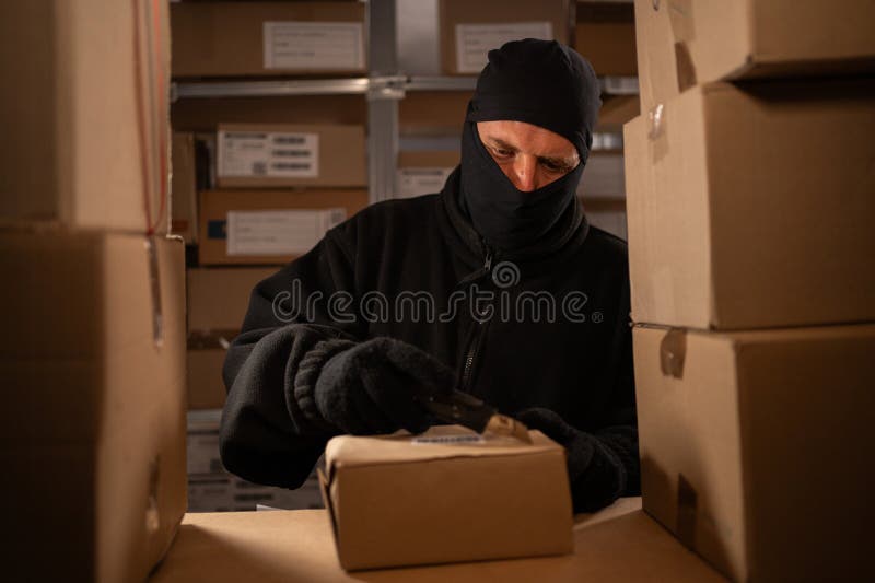 Warehouse Thief Stealing Boxes of Goods at Night. the Concept of ...