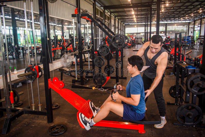 A Male Trainer Shows the Correct Exercise Postures for the Trainees To ...