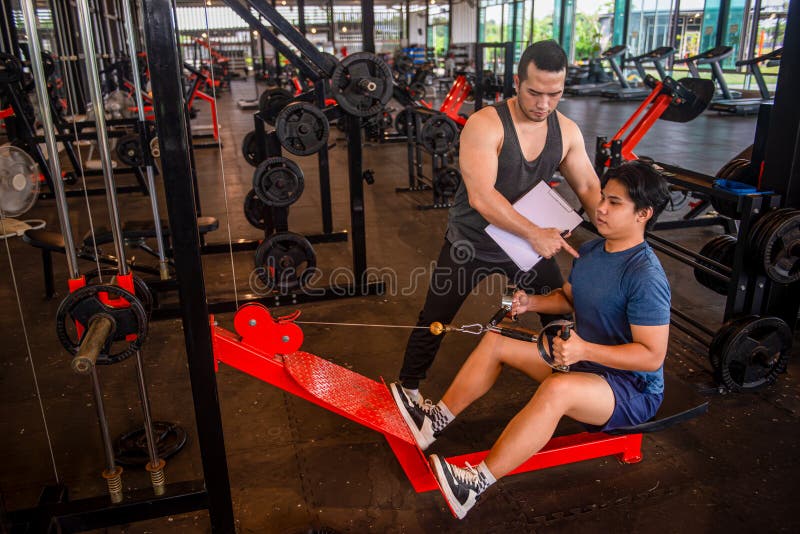 A Male Trainer Shows the Correct Exercise Postures for the Trainees To ...