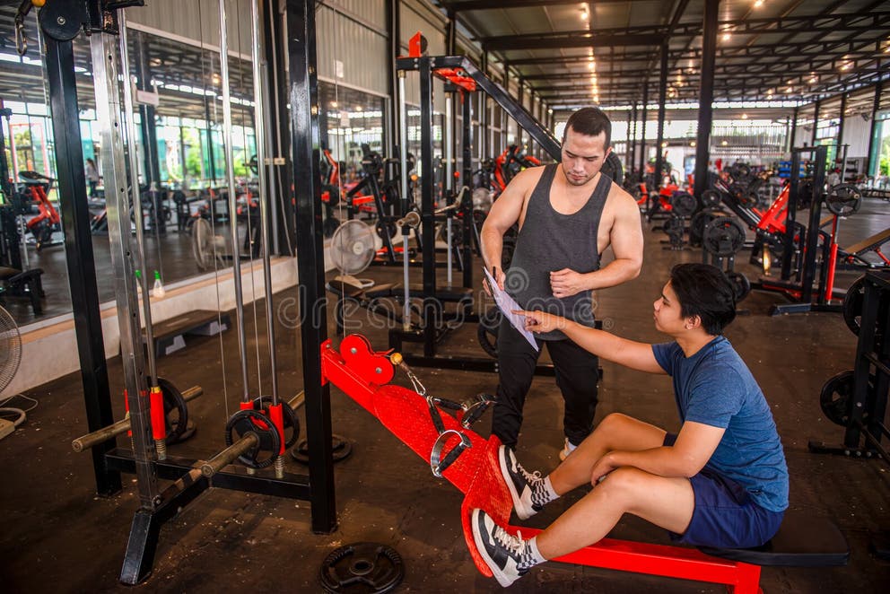 Male Trainer Shows the Exercise Program To the Trainee and Plans the ...