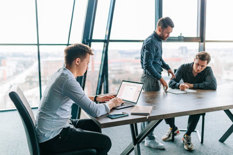A Male Trainer Teaching a Group of Trainees How To Use a New Software ...