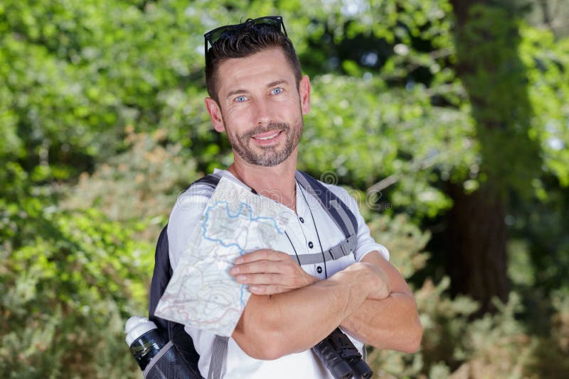 Male traveler holding map stock image. Image of nature - 172817299