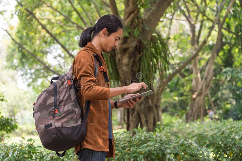 Male Travelers with Backpack Using Gps Map on Tablet for Sightseeing in ... Male Travelers with Backpack Using Gps Map on Tablet for Sightseeing in ...