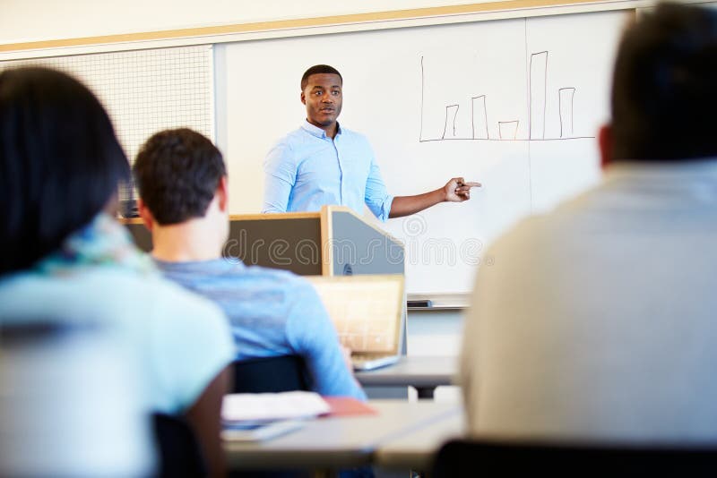 Male Tutor Teaching University Students in Classroom Stock Image ...