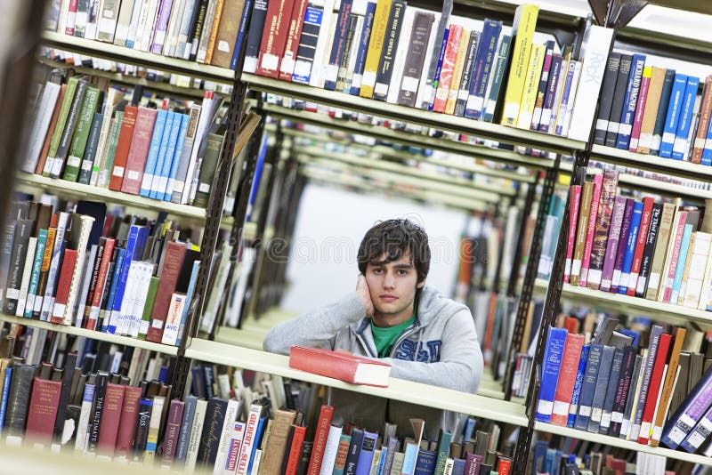 Male University Student Amid Books in Library Editorial Stock Image ...