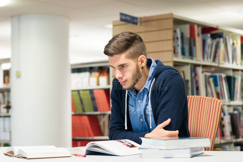 Male University Student in the Library Stock Image - Image of table ...
