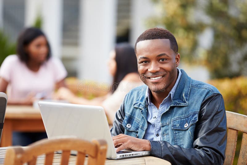 Male University Student Working on Project Outdoors Stock Photo - Image ...
