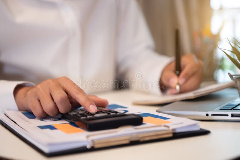 Male Use the Calculator and Take Notes with Calculations about the ...