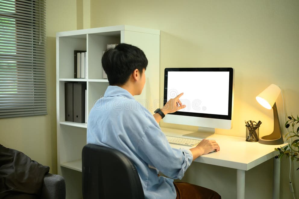 Male User Browsing or Working on a Large Computer Screen in a ...