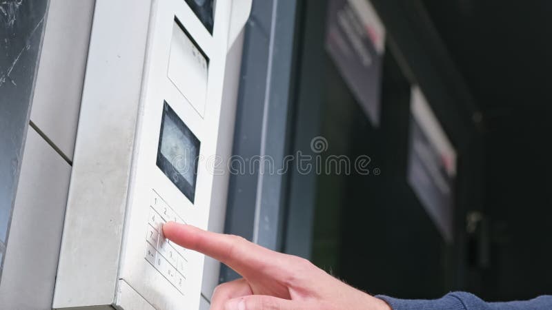 Male Using Intercom at Residential Building Entrance. Opens Electronic ...