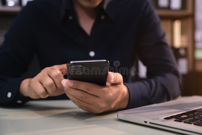 Male are Using a Mobile Phone Search Information on the Desk in the ...
