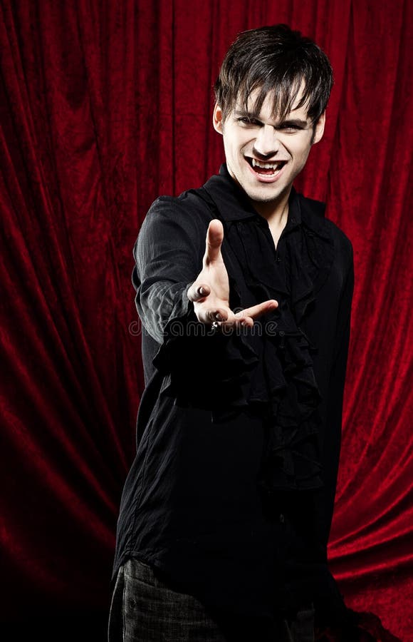 Male Vampire Smiling Dangerously, Showing Fangs Stock Photo - Image of ...