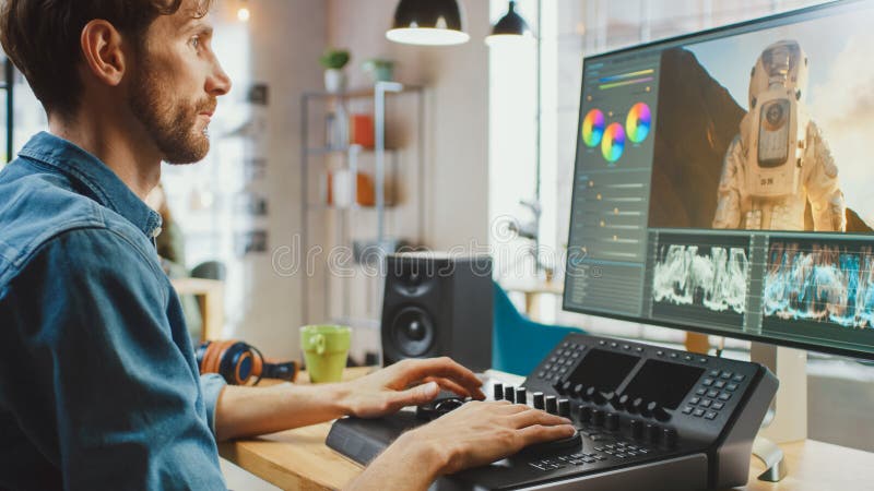 Male Video Editor with Beard and Jeans Shirt Works with Footage on His ...