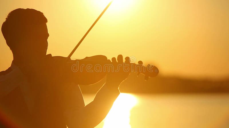 Male Violinist Playing the Violin at the Lake at Sunset Stock Footage ...