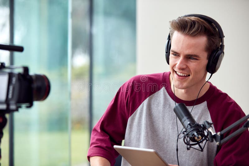 Male Vlogger with Digital Tablet Recording Video at Home with Camera ...