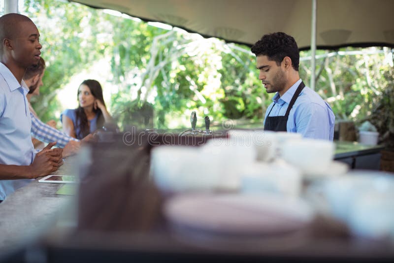 Male Waiter Taking Order at Counter Stock Image - Image of food ...