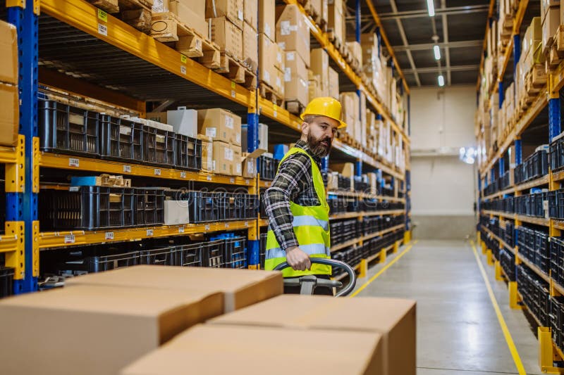 Male Warehouse Worker Dragging a Pallet Truck. Stock Photo - Image of ...
