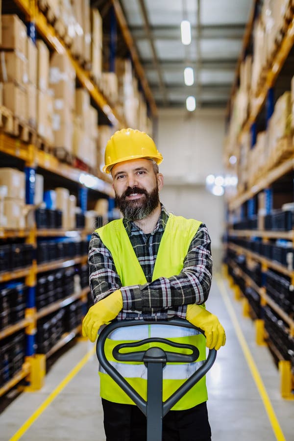 Male Warehouse Worker Pushing a Pallet Truck. Stock Image - Image of ...