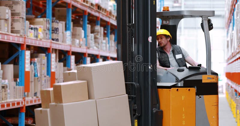 Warehouse Worker Transporting Goods with Forklift Stock Footage - Video ...