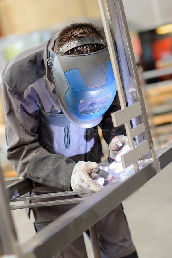 Male welder at work stock image. Image of overalls, male - 244332363