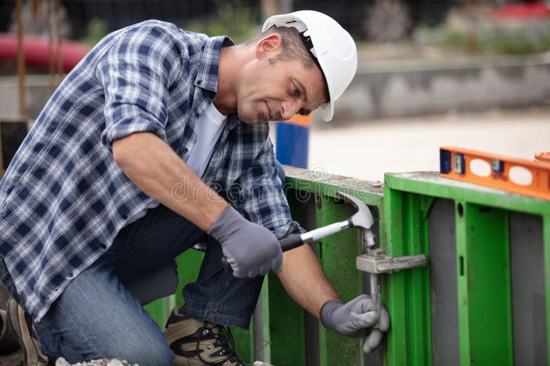 Male Worker Adjusting Clamp on Site Shuttering Stock Photo - Image of ...