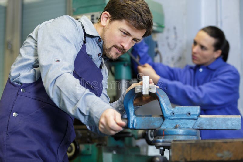Male Worker Adjusting Clamp on Vice Stock Photo - Image of business ...