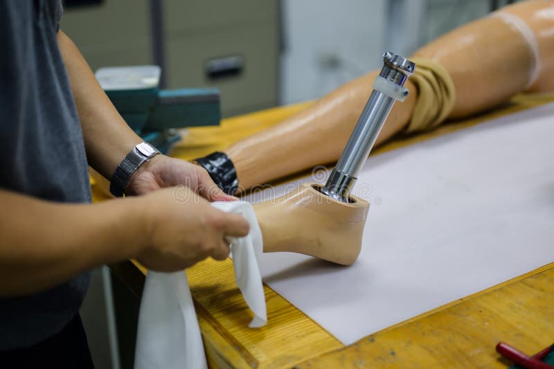 Male Worker Assembling Parts of Artificial Leg in Prosthetic Workshop ...