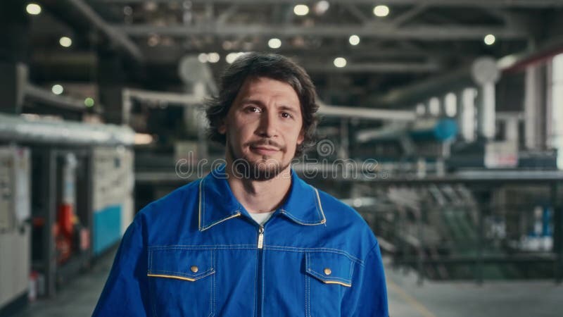 A Male Worker in a Blue Uniform Walks through the Workshop of a Modern ...