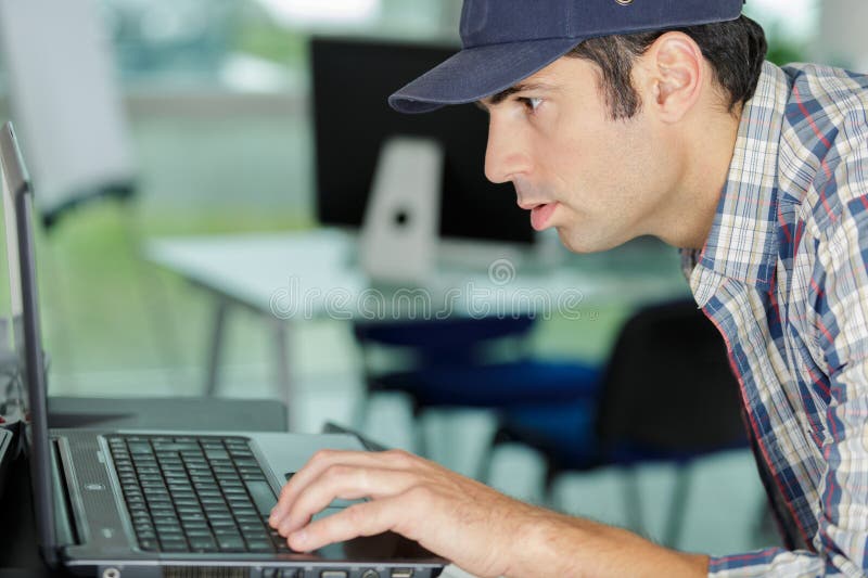 Male Worker Checking Laptop Stock Photo - Image of young, laborer ...